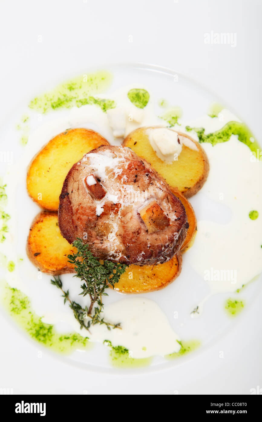 roast meat with potatoes on white plate Stock Photo - Alamy