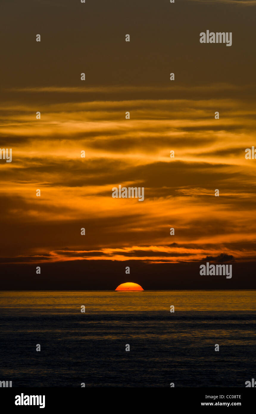 A beautiful golden sunset just before the sun disappeares below the ...