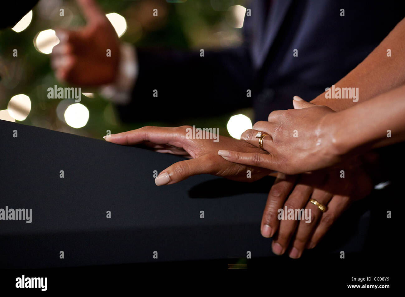 First lady Michelle Obama holds hands with President Barack Obama ...
