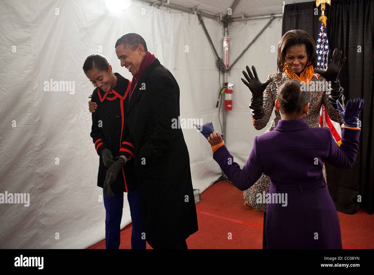 President Barack Obama hugs daughter Malia as first lady Michelle plays ...