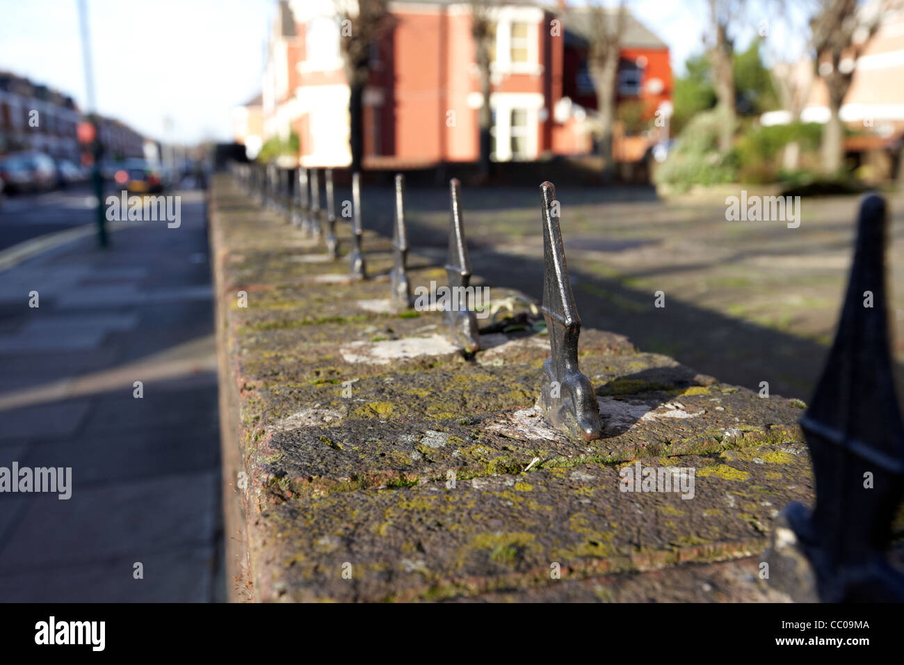 row of painted metal wrought iron spikes to stop people sitting on a ...