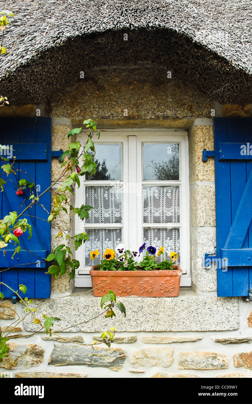 Typical thatched cottage in Brittany France, close up of pretty window ...