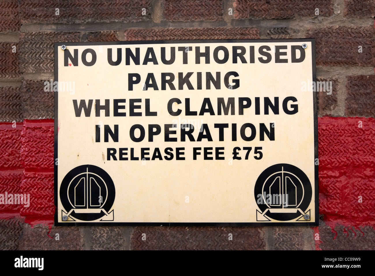 no unauthorised parking wheel clamp in operation release fee sign on a ...