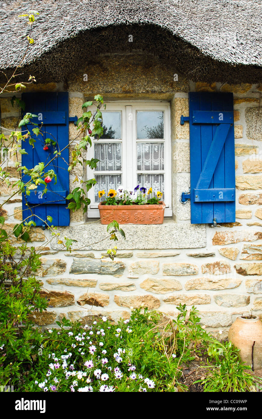 Typical thatched cottage in Brittany France, close up of pretty window ...