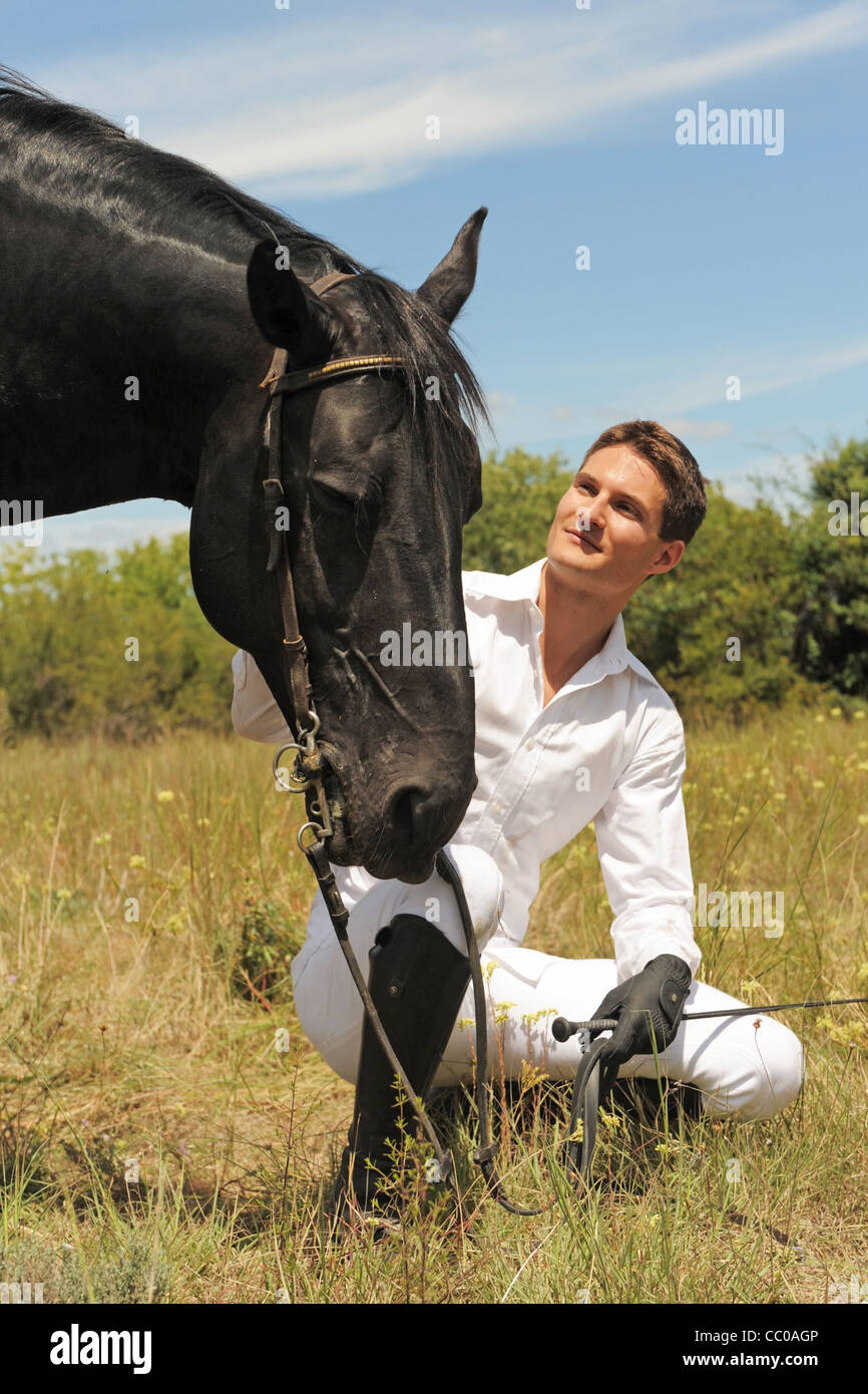 Young man beautiful black stallion hi-res stock photography and images ...