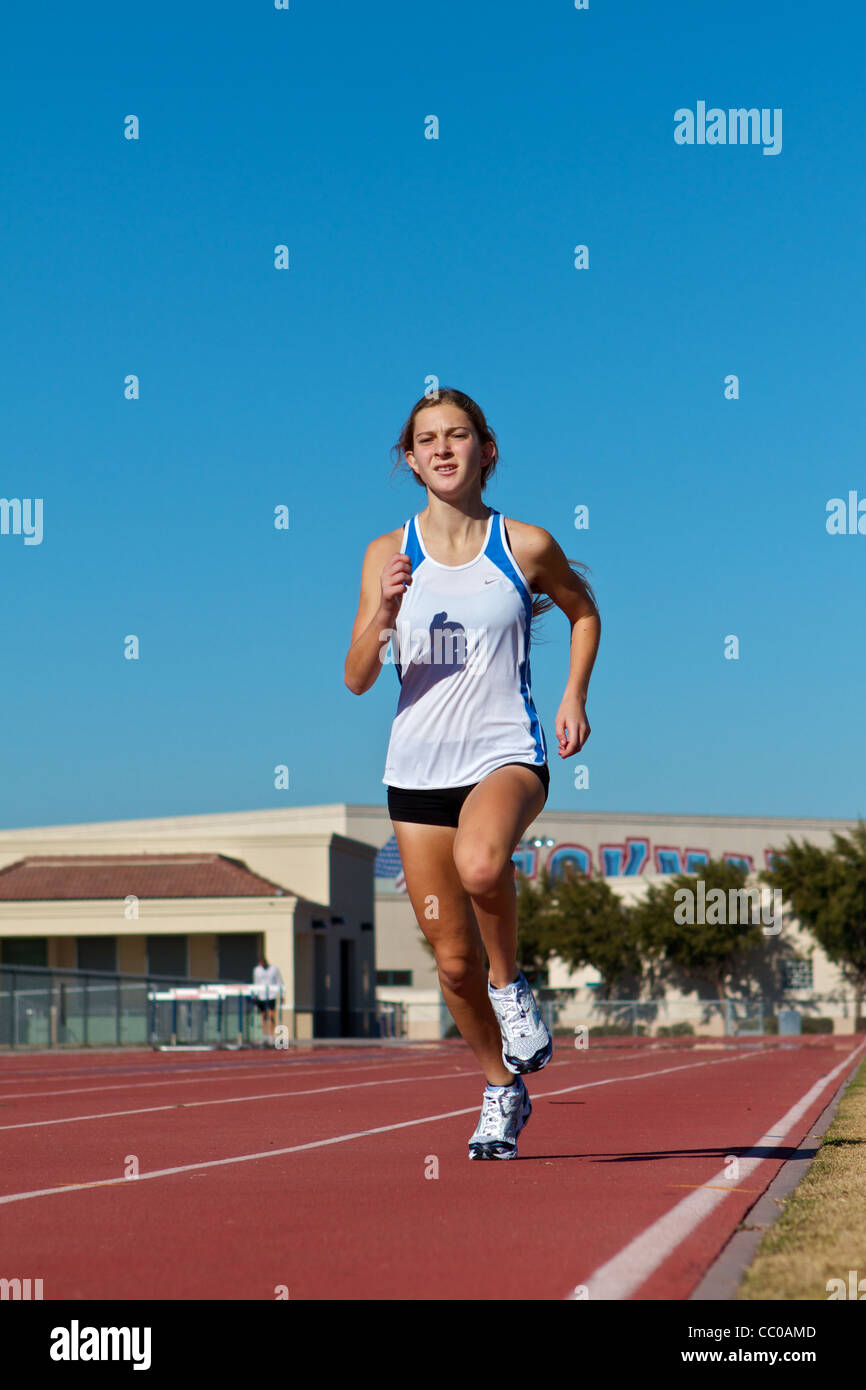 Young female Athlete running on a track front low angle Stock Photo - Alamy