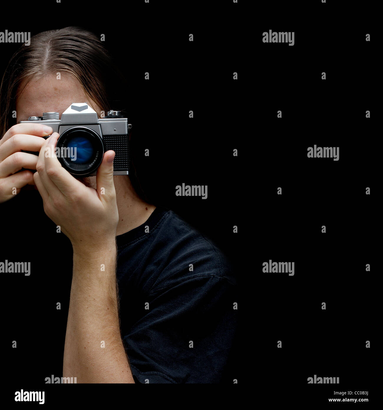 Photographer with an old film camera isolated on black Stock Photo - Alamy