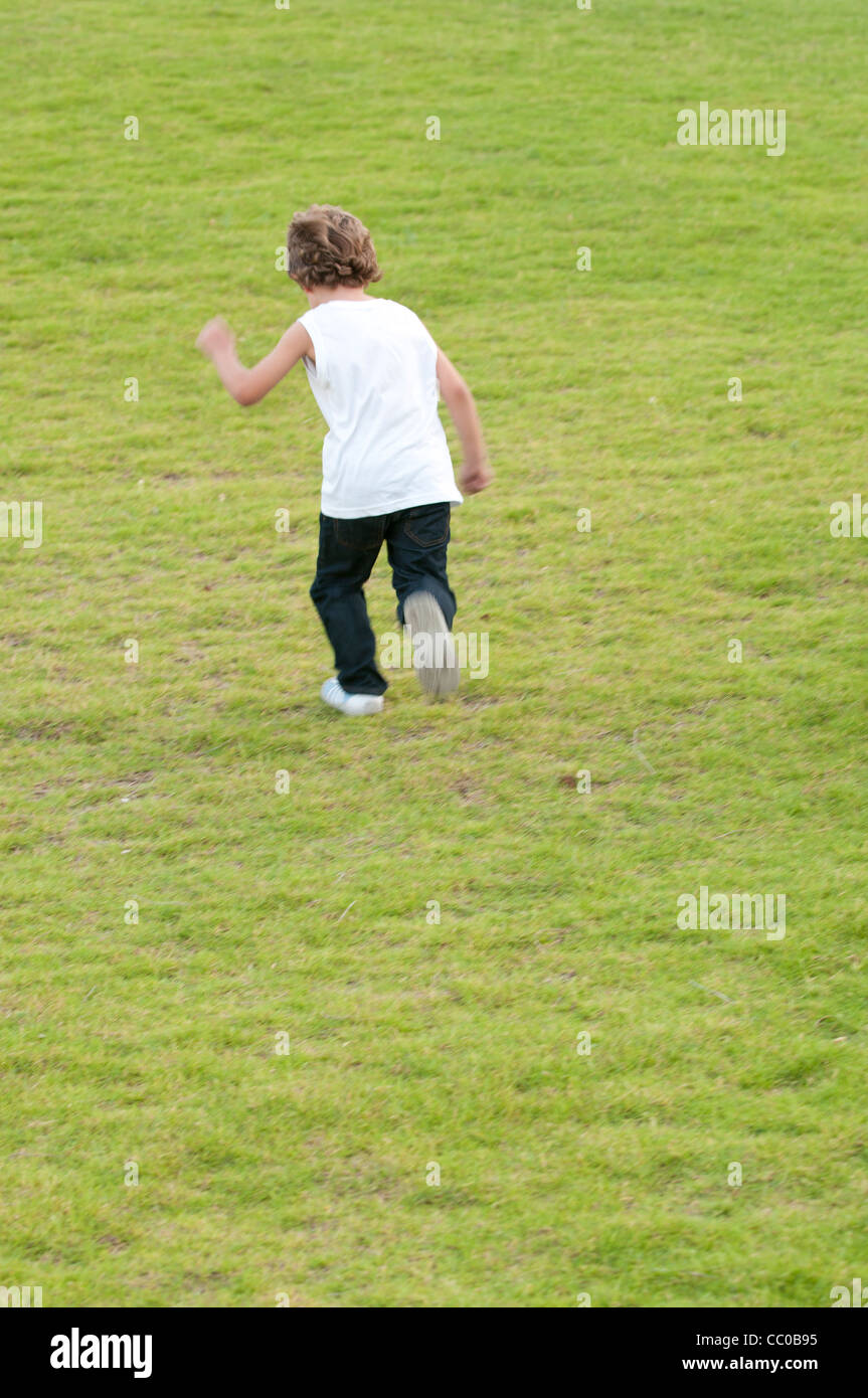Little boy running in the field Stock Photo - Alamy
