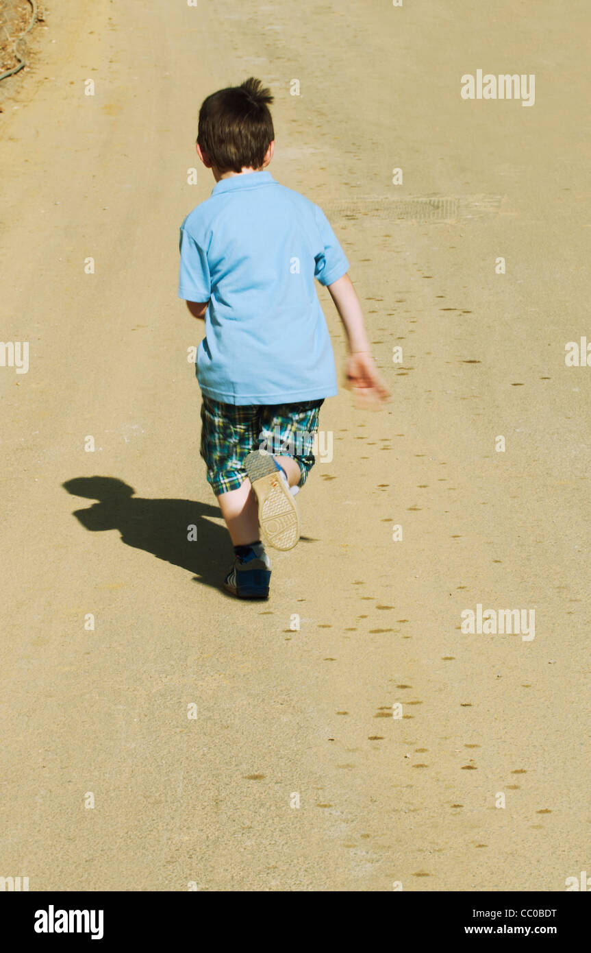 young boy running away Stock Photo - Alamy