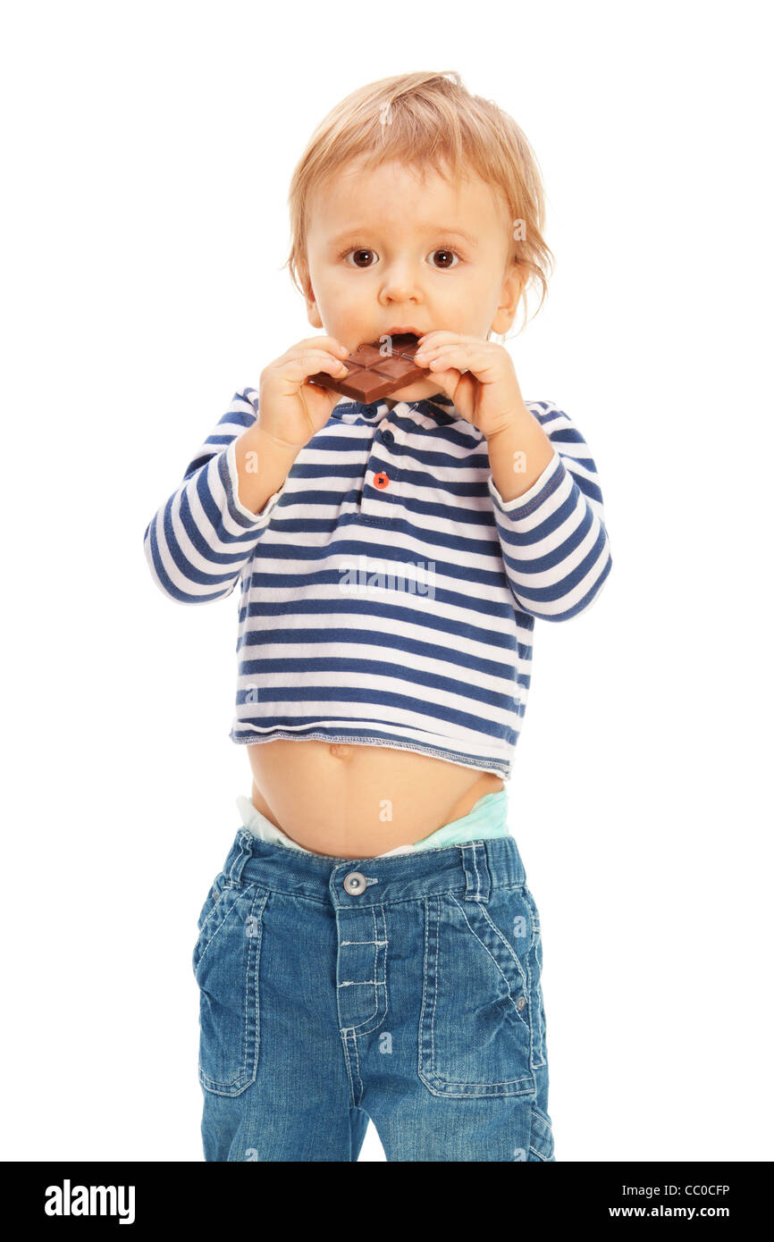 Cute kid eating chocolate bar looking at camera Stock Photo - Alamy