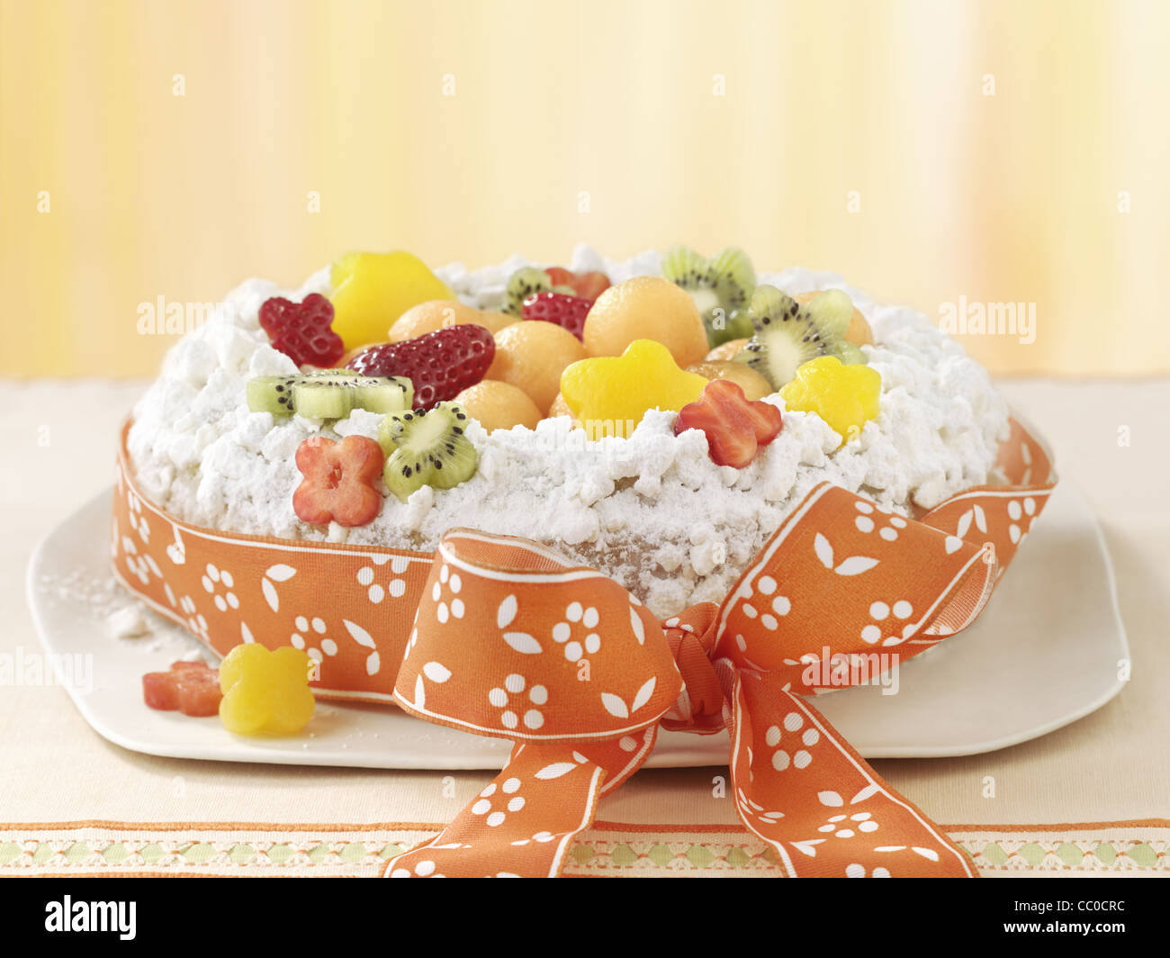 Lemon savarin cake with mixed fruits Stock Photo - Alamy