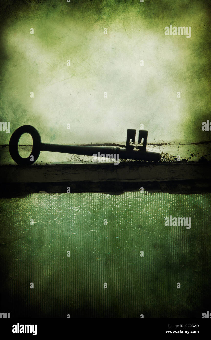 Old fashioned key silhouetted against the window Stock Photo - Alamy