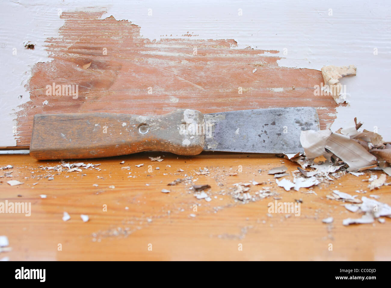 Filler knife or paint scraper in a pile of removed paint flakes Stock ...