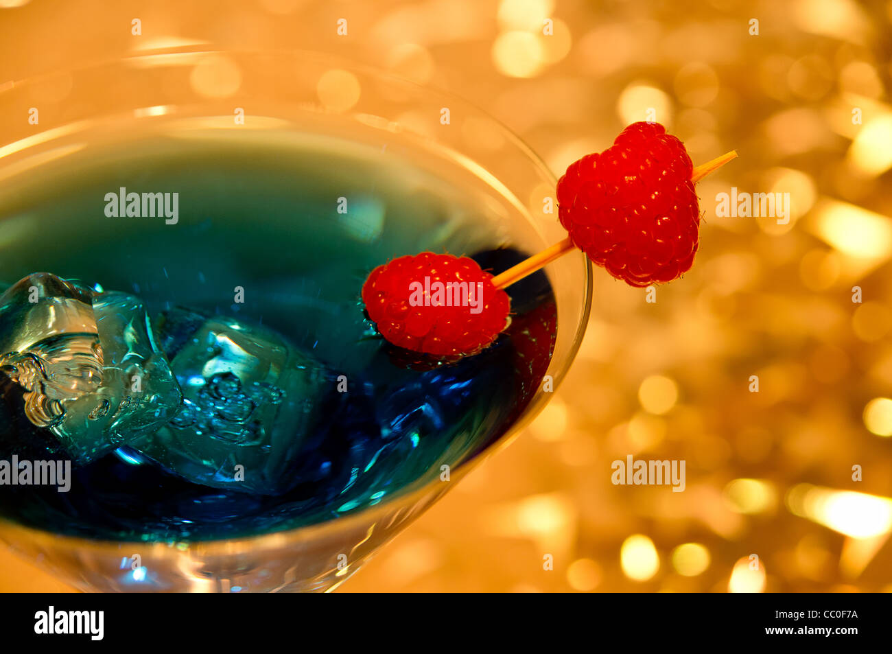 blue cocktail with raspberry Stock Photo - Alamy