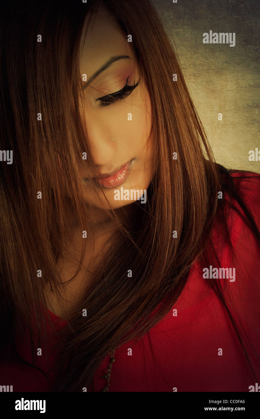 Thoughtful young woman hair covering face looking down Stock Photo - Alamy