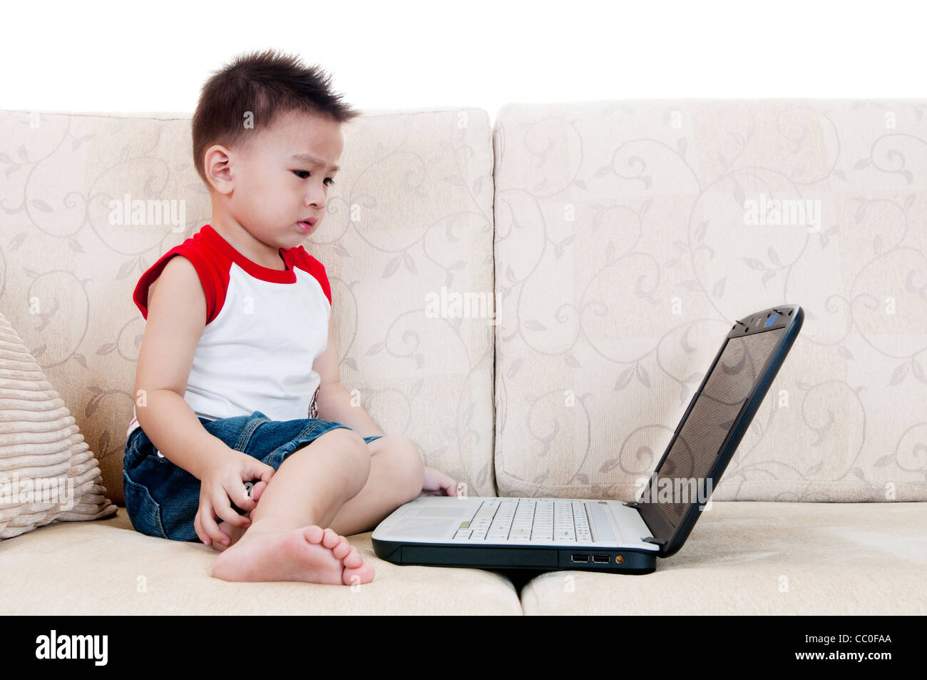Young Asian concentrate looking at laptop screen Stock Photo - Alamy