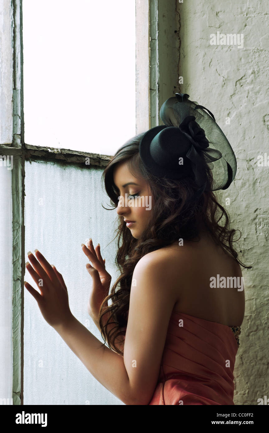 Sad woman by the window Stock Photo - Alamy