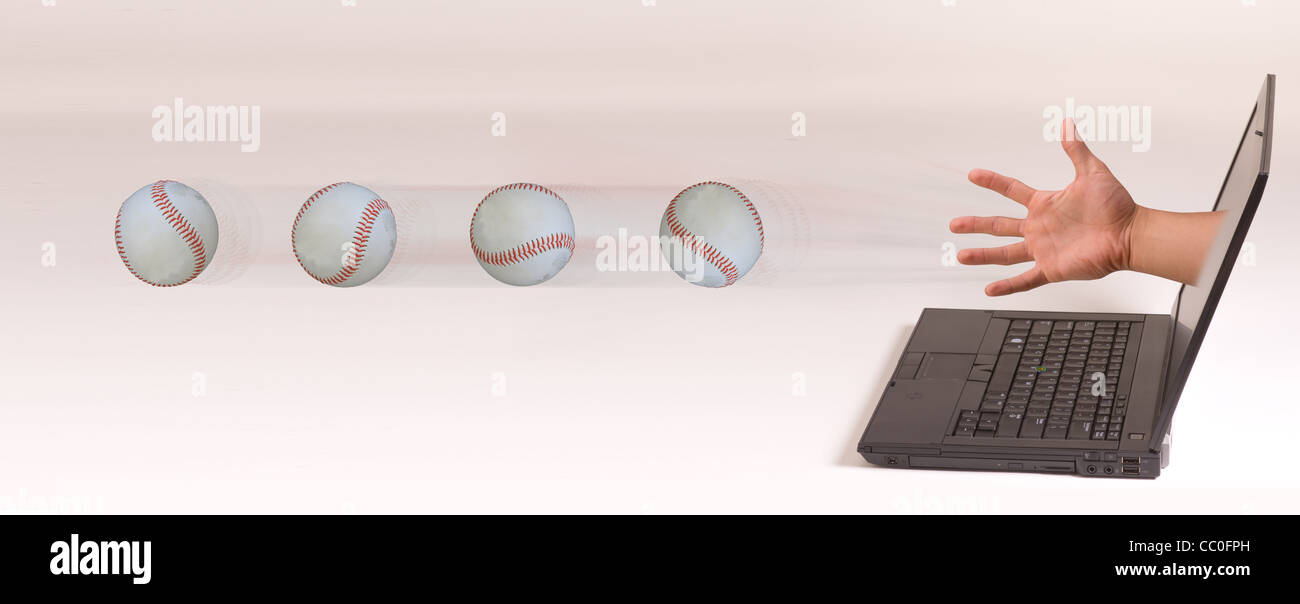 Throw baseballs out of the computer screen Stock Photo - Alamy