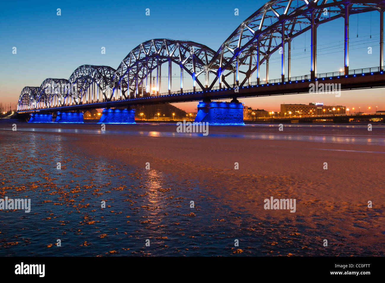Railway bridge at night in winter close up Stock Photo - Alamy