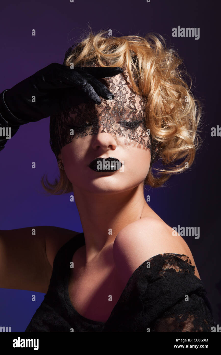 Tired beautiful blond woman with lace bandage on her face with ...