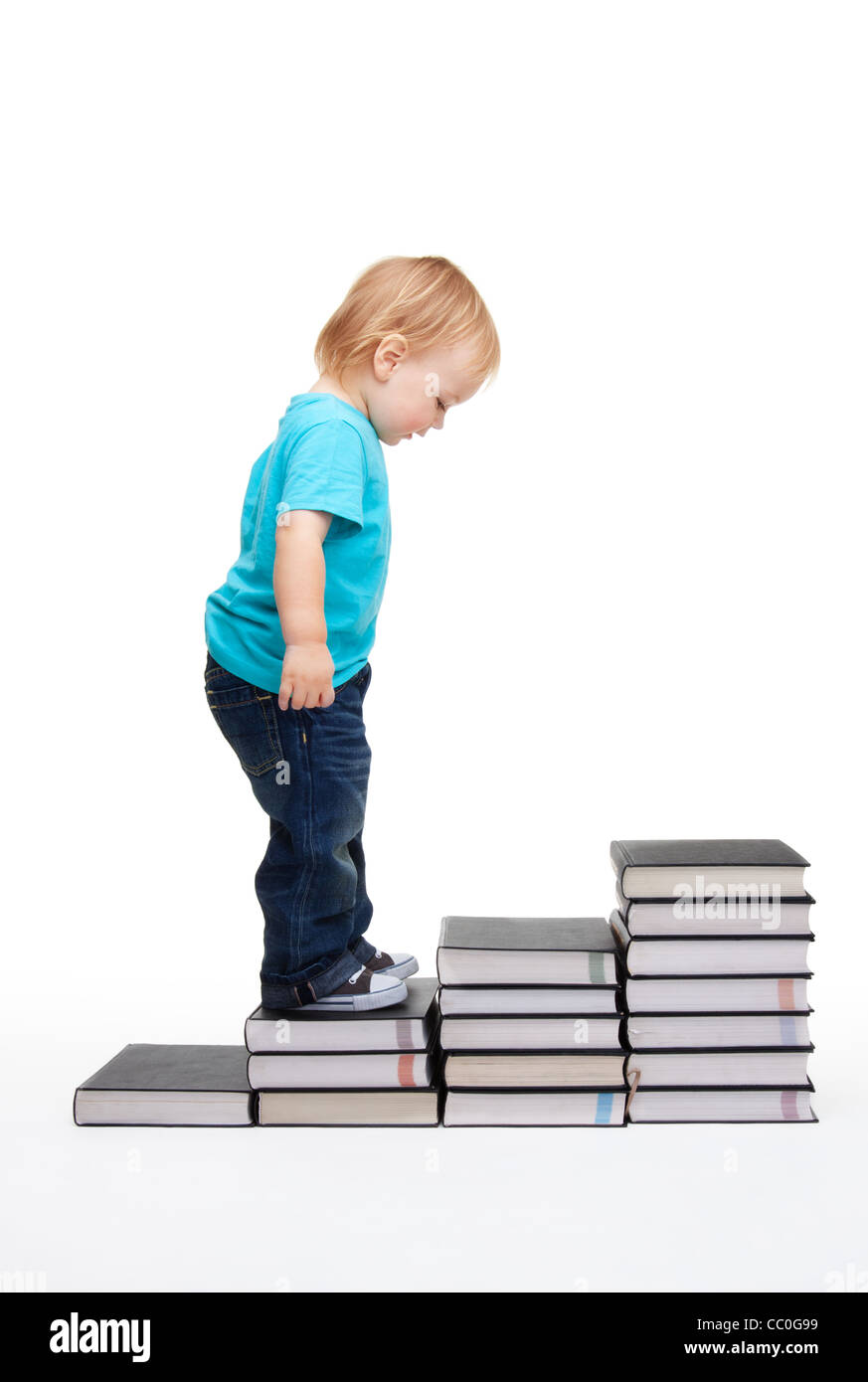First steps of education - kid on steps made of books Stock Photo - Alamy