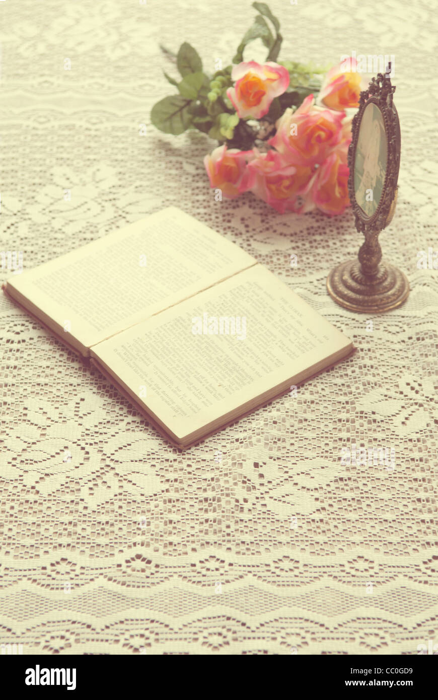 Open book next to oval shaped frame and a bouquet of roses Stock Photo ...