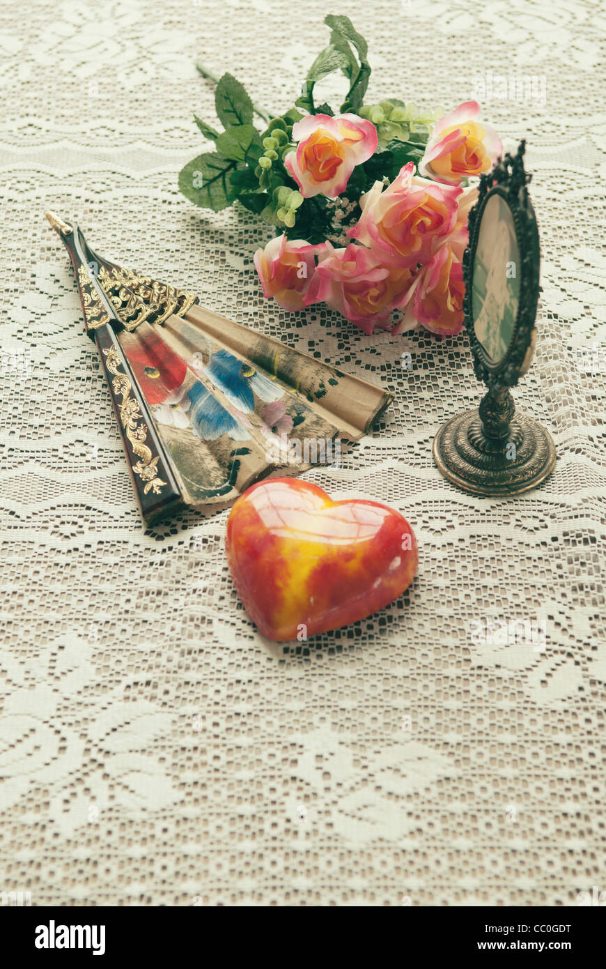 Glass heart , fan, roses and oval frame Stock Photo - Alamy