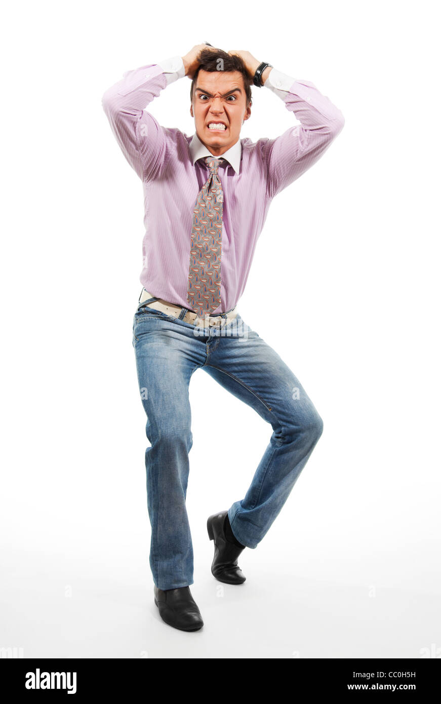 A man grasp his head with his hands and with grimace on his face when ...