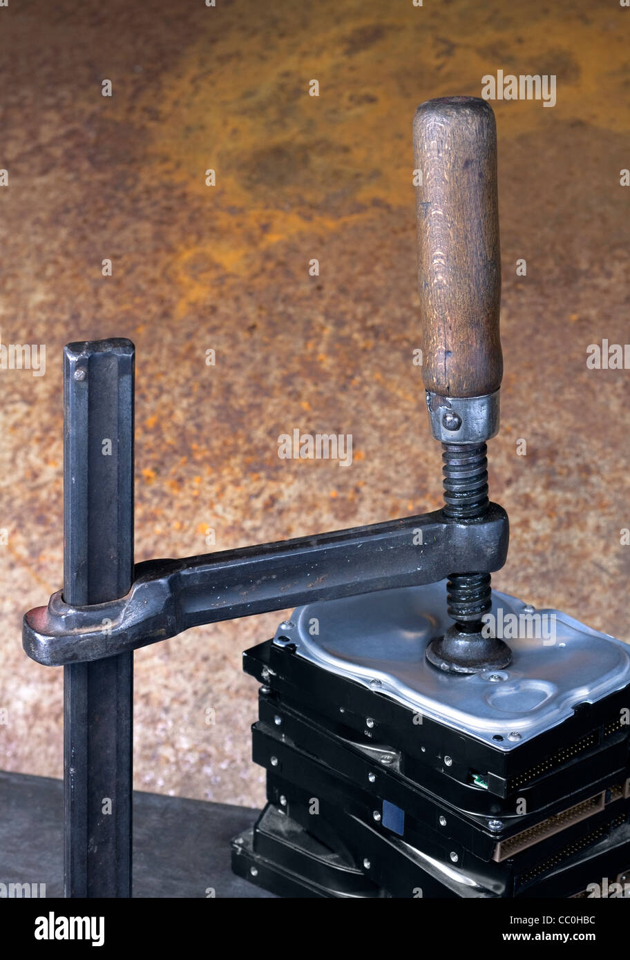 detail shot showing some hard disk drives compressed with a screw clamp ...