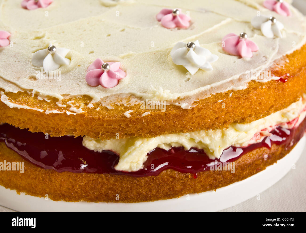 Home baked Victoria sponge cake with buttercream and raspberry jam ...