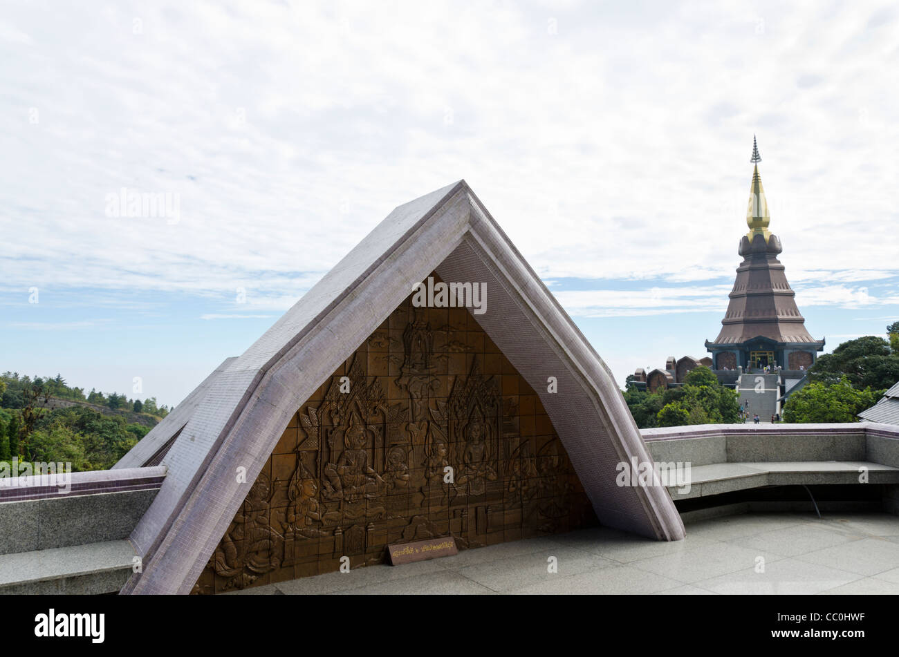 Carved wood Buddhist mural at Queen's pagoda with King's pagoda in ...