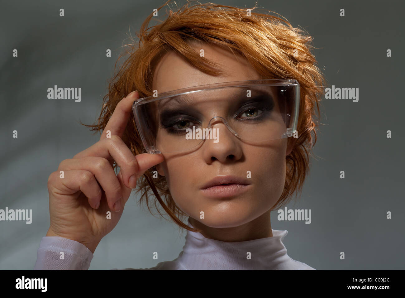 Close-up portrait of beautiful clever woman with red heir and glasses ...