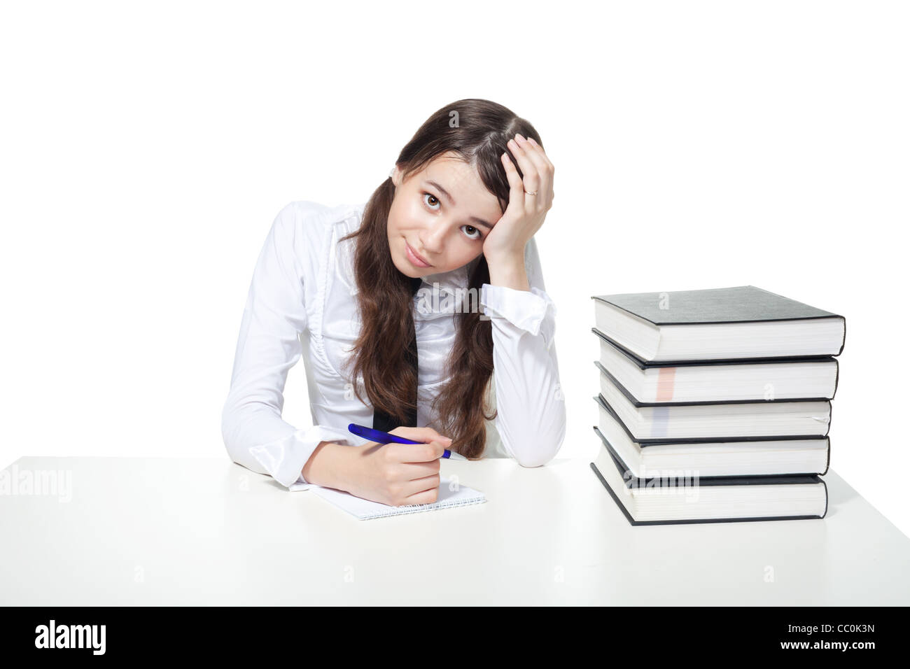 Sad girl sitting with books trying to made up a story Stock Photo - Alamy