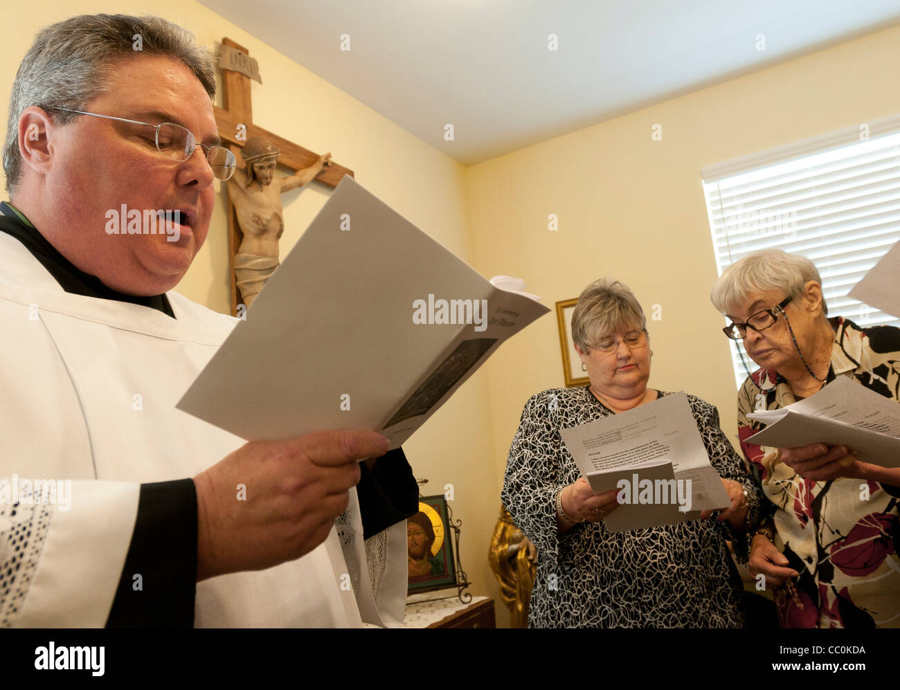 Father Charles Hough, second from left, leads his congregation in ...