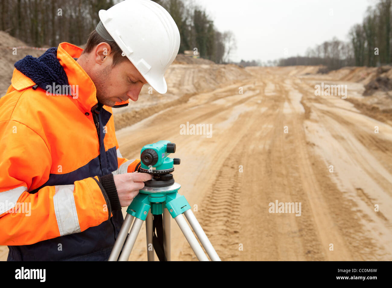 Land surveyor working on a construction site Stock Photo - Alamy