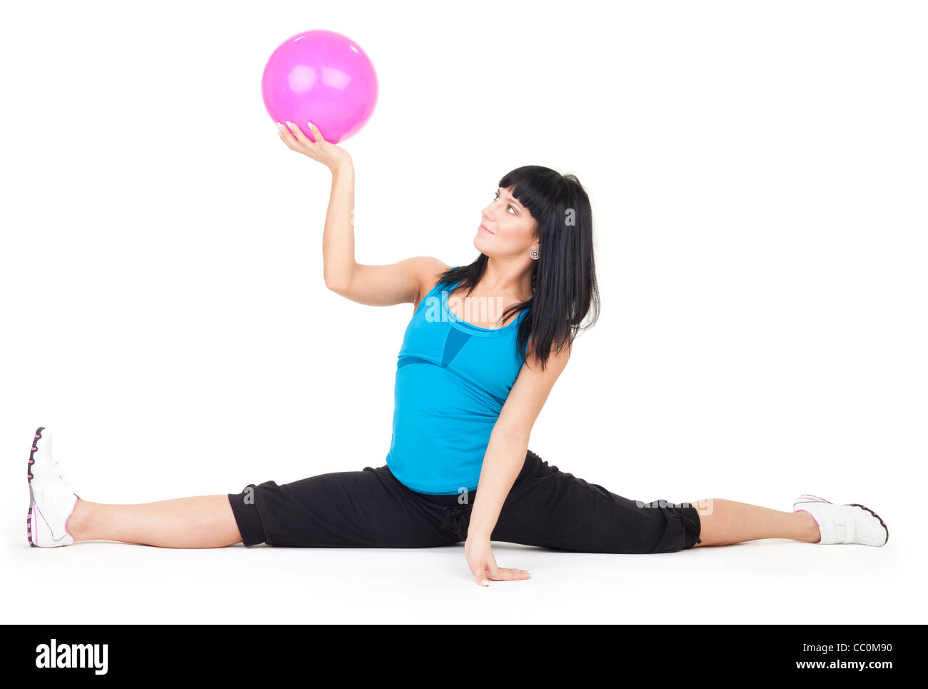 Woman exercise with ball doing splits on white background Stock Photo ...