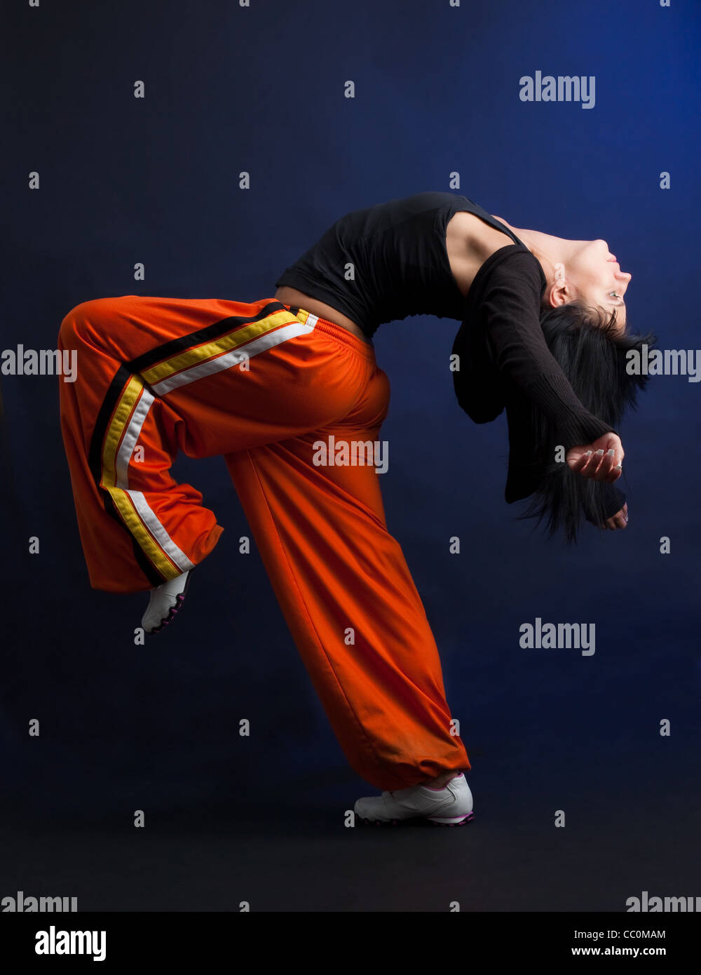 Modern style dancer woman performing on dark background Stock Photo - Alamy