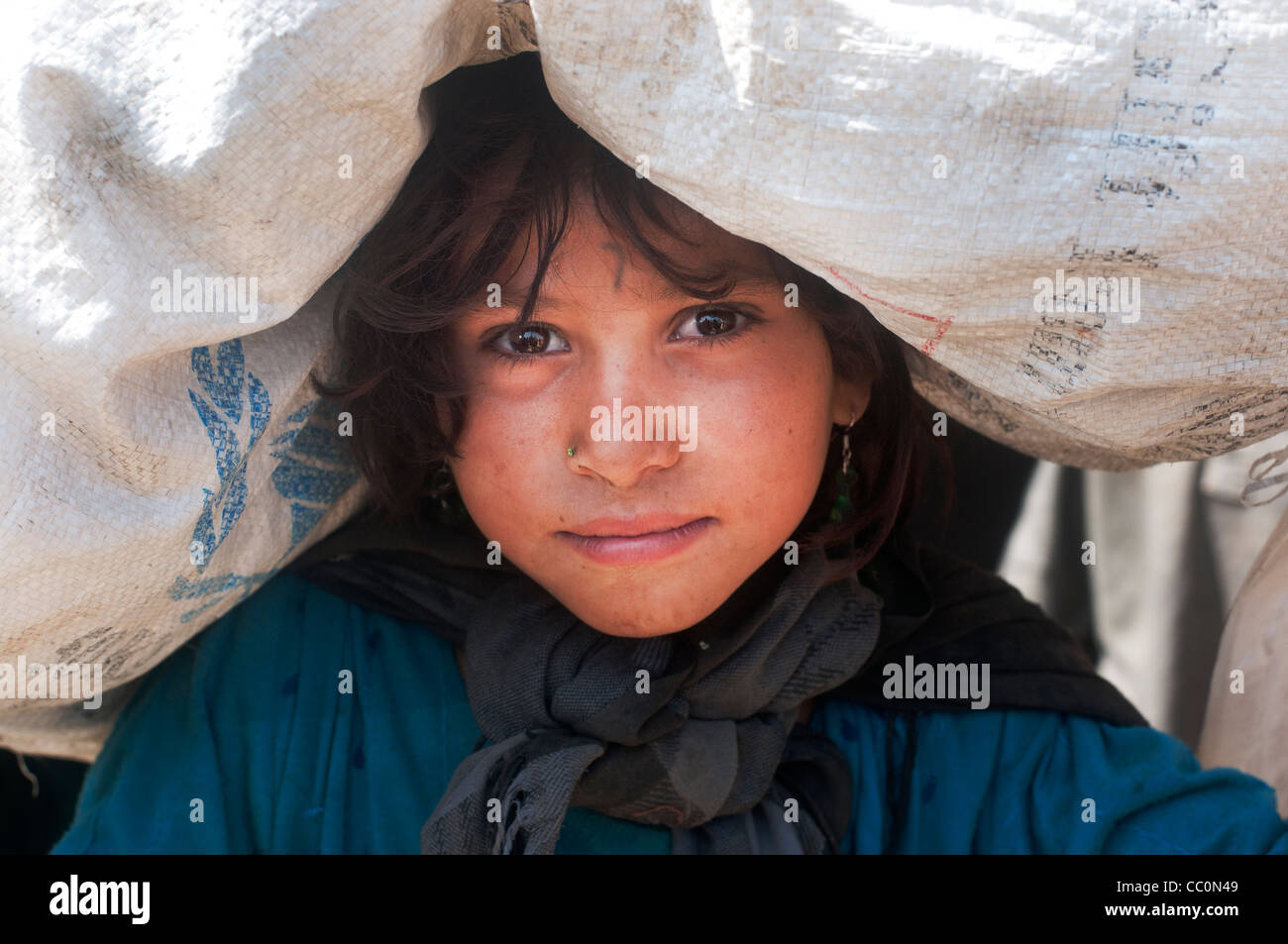 Kabul. People displaced from Helmand province - young girl carrying a ...