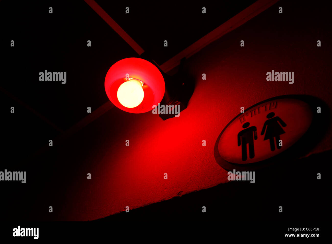 Red light over a public toilet sign i Stock Photo - Alamy