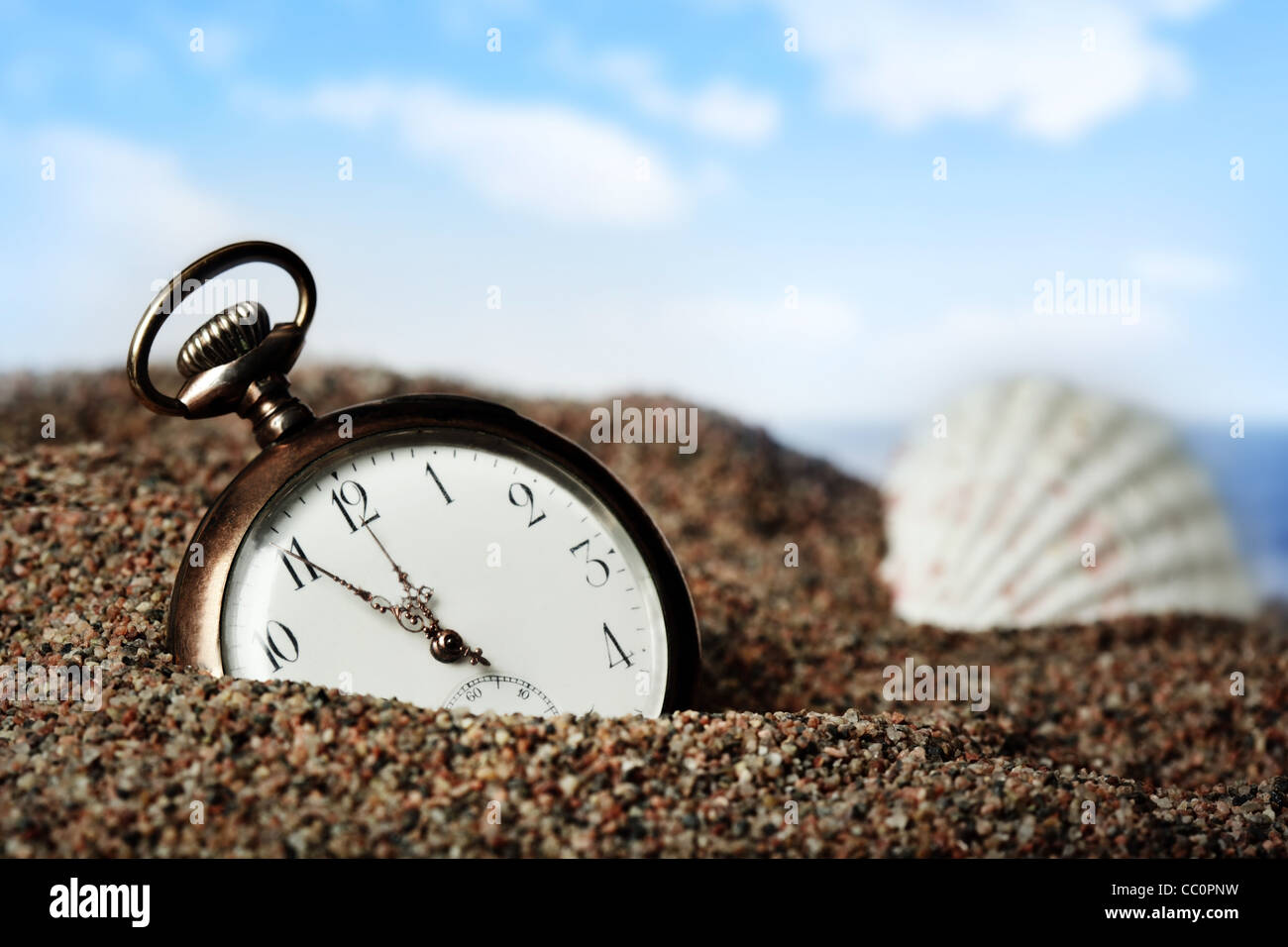 Old pocket watch buried in sand Stock Photo - Alamy