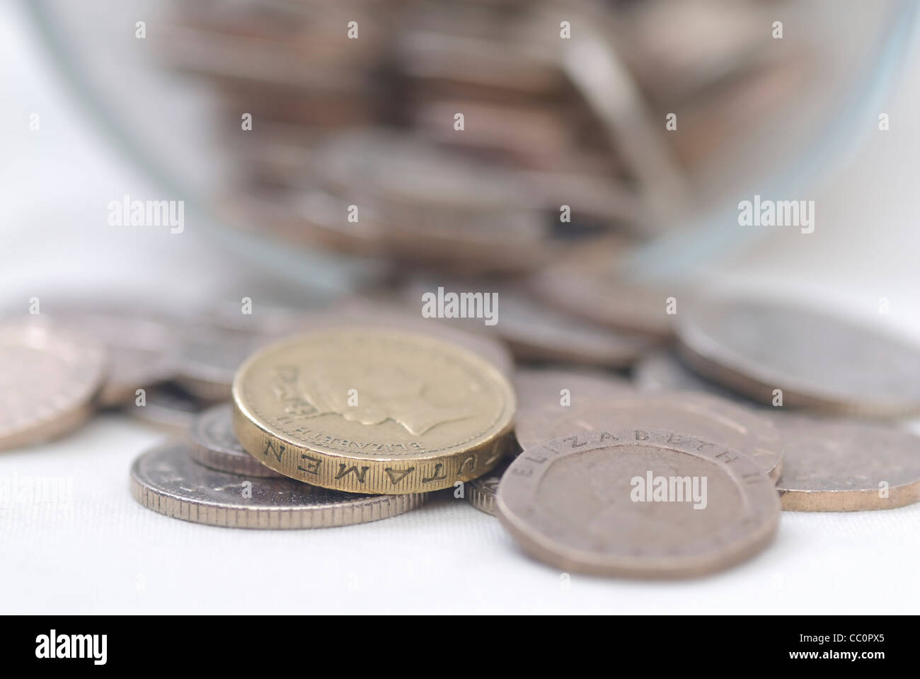 Spilled Coins from Glass Jar, focus on £1 coin. Sterling Stock Photo ...