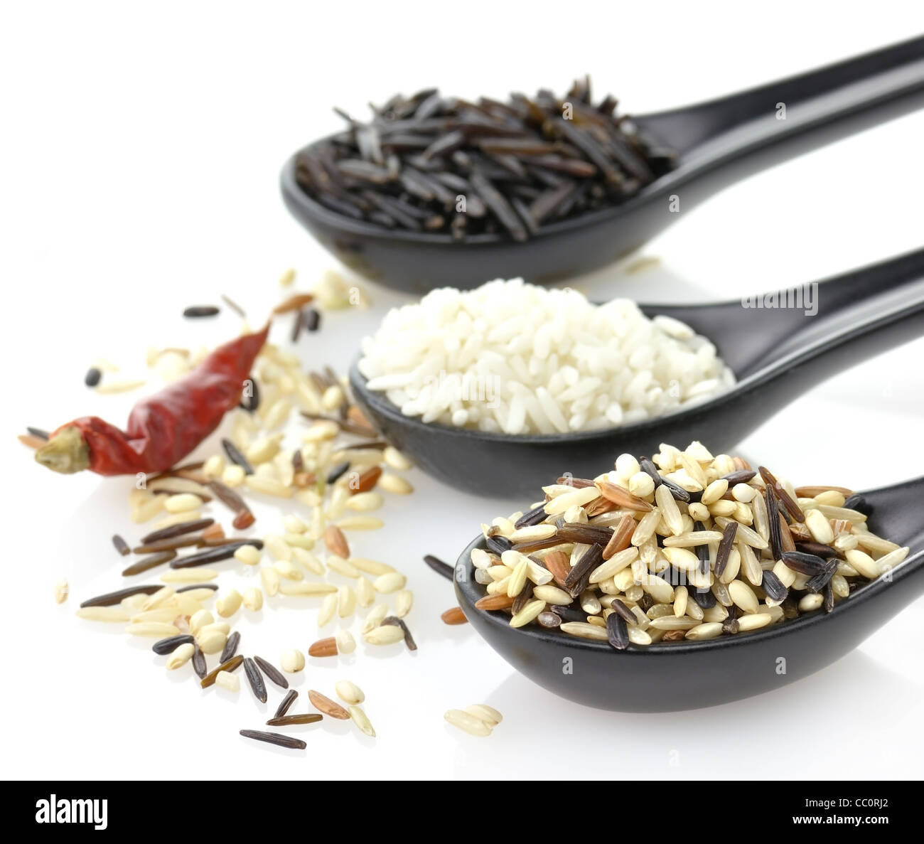 Assortment Of Rice In The Black Spoons Stock Photo - Alamy