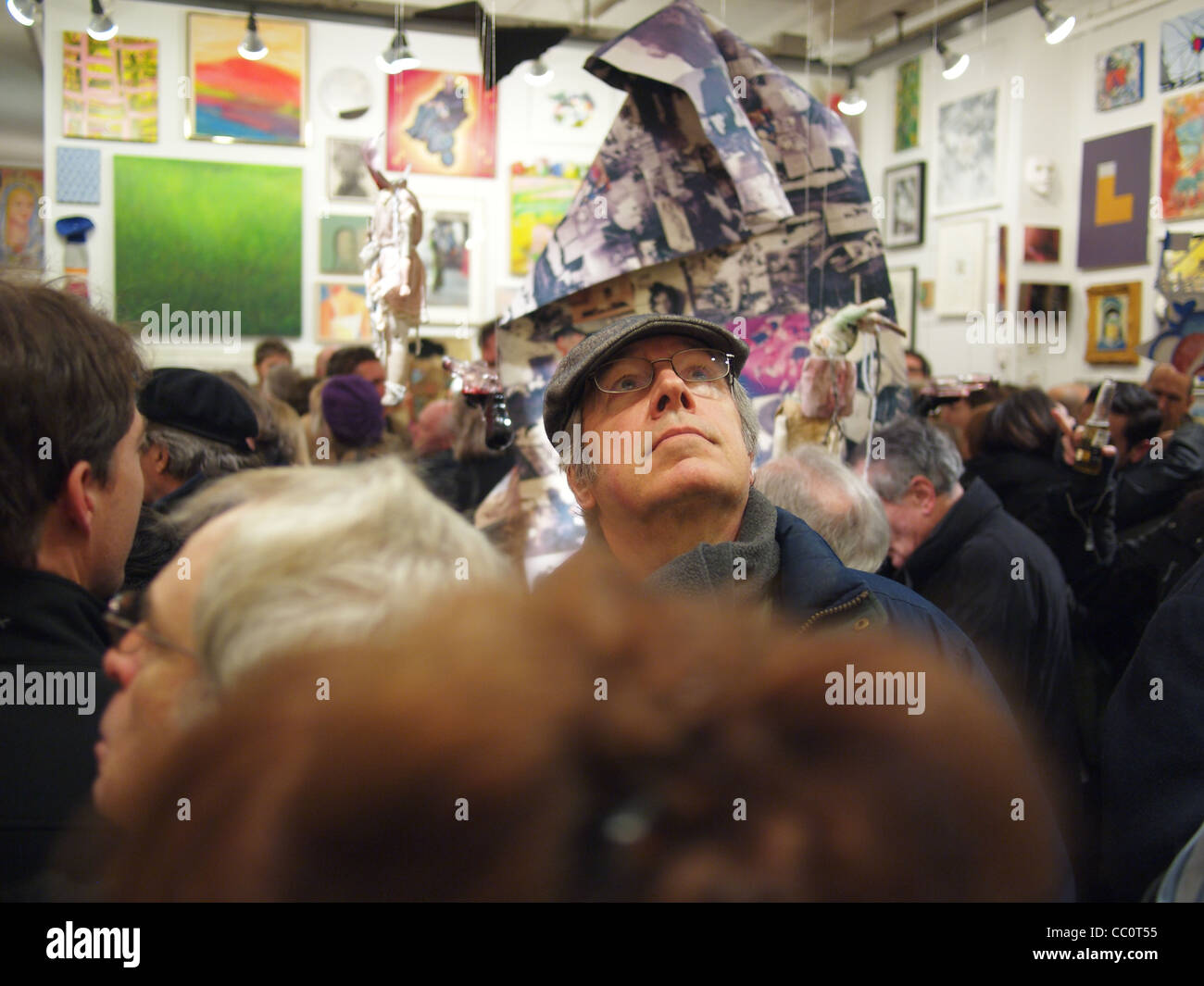 Guest at crowded art opening, Sideshow Gallery, Brooklyn, New York ...