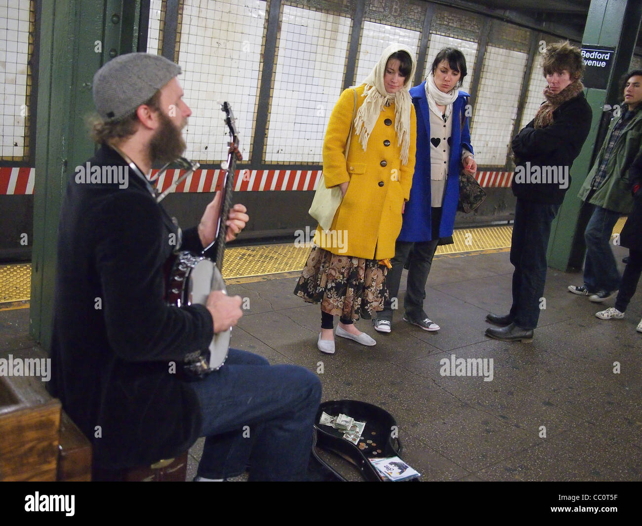 Musician in New York City subway plays banjo as others listen Stock ...