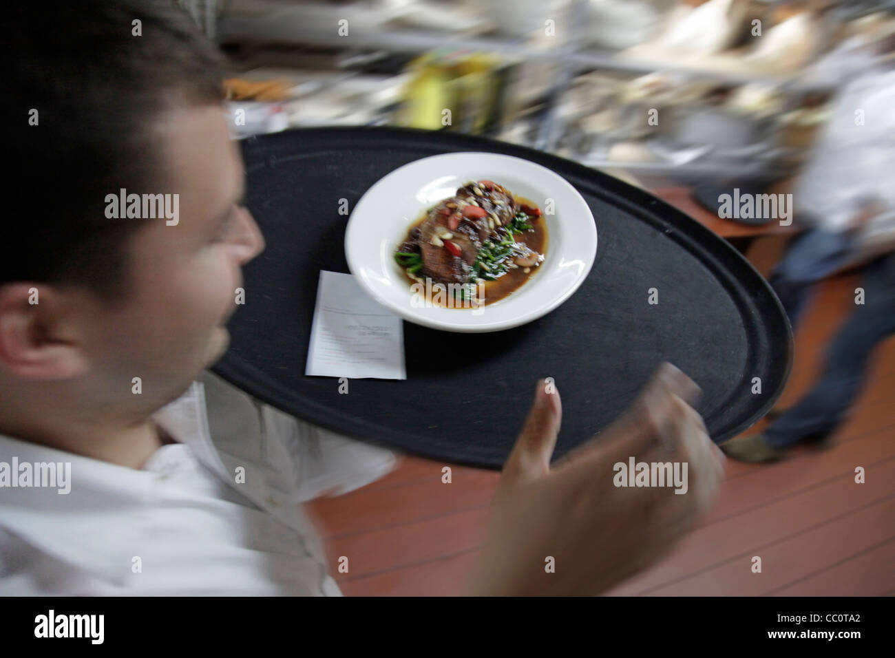 Male server carrying plates hi-res stock photography and images - Alamy