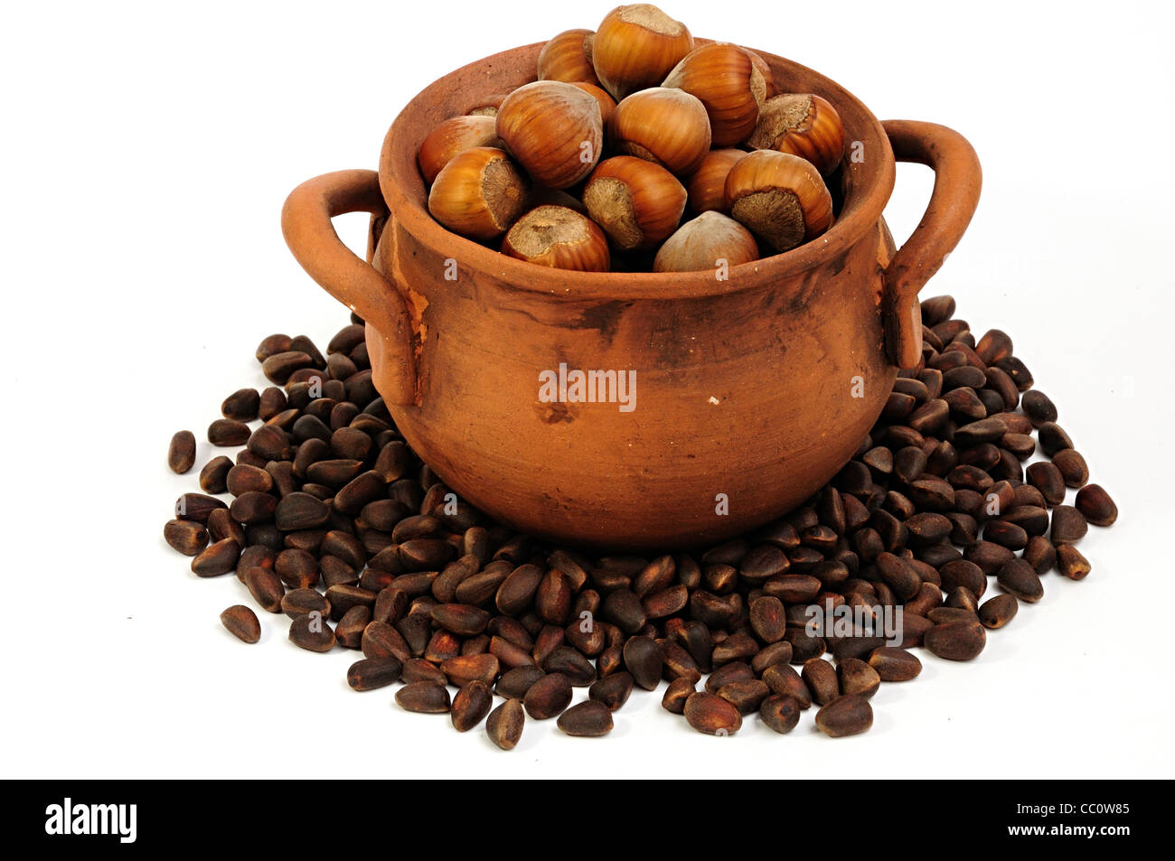 pot with hazelnuts, cedar nuts surrounded, isolated, close-up Stock ...