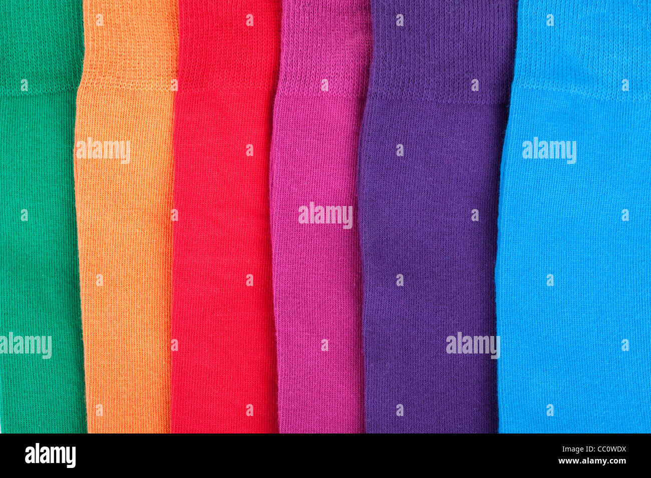 Different color textile fabrics clothes lay in row Stock Photo - Alamy