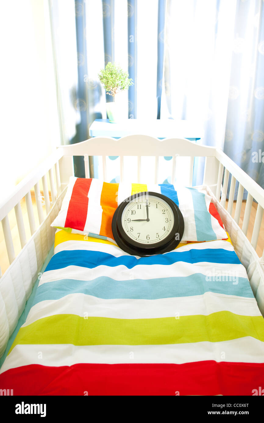 Expecting child - baby bed and clock as symbol of expectation Stock ...