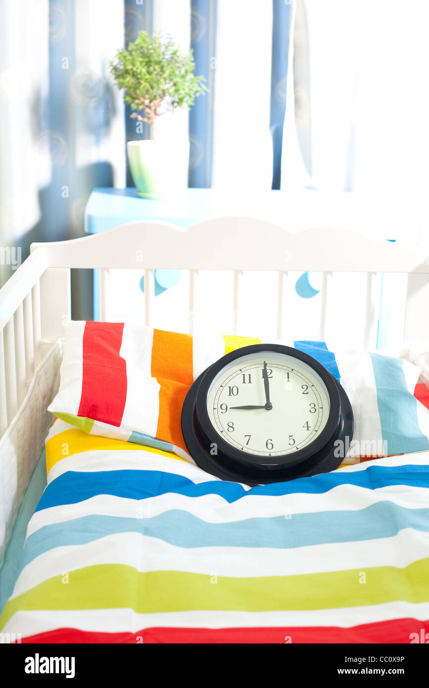 expecting baby - little bed with clock at nine month time Stock Photo ...