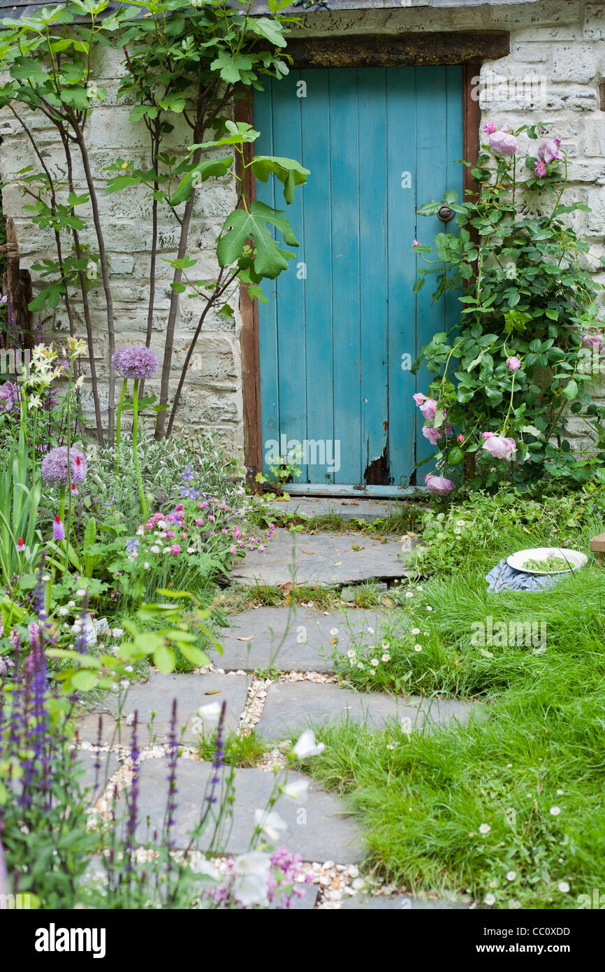 Stone path leading to the blue painted entrance door Stock Photo - Alamy